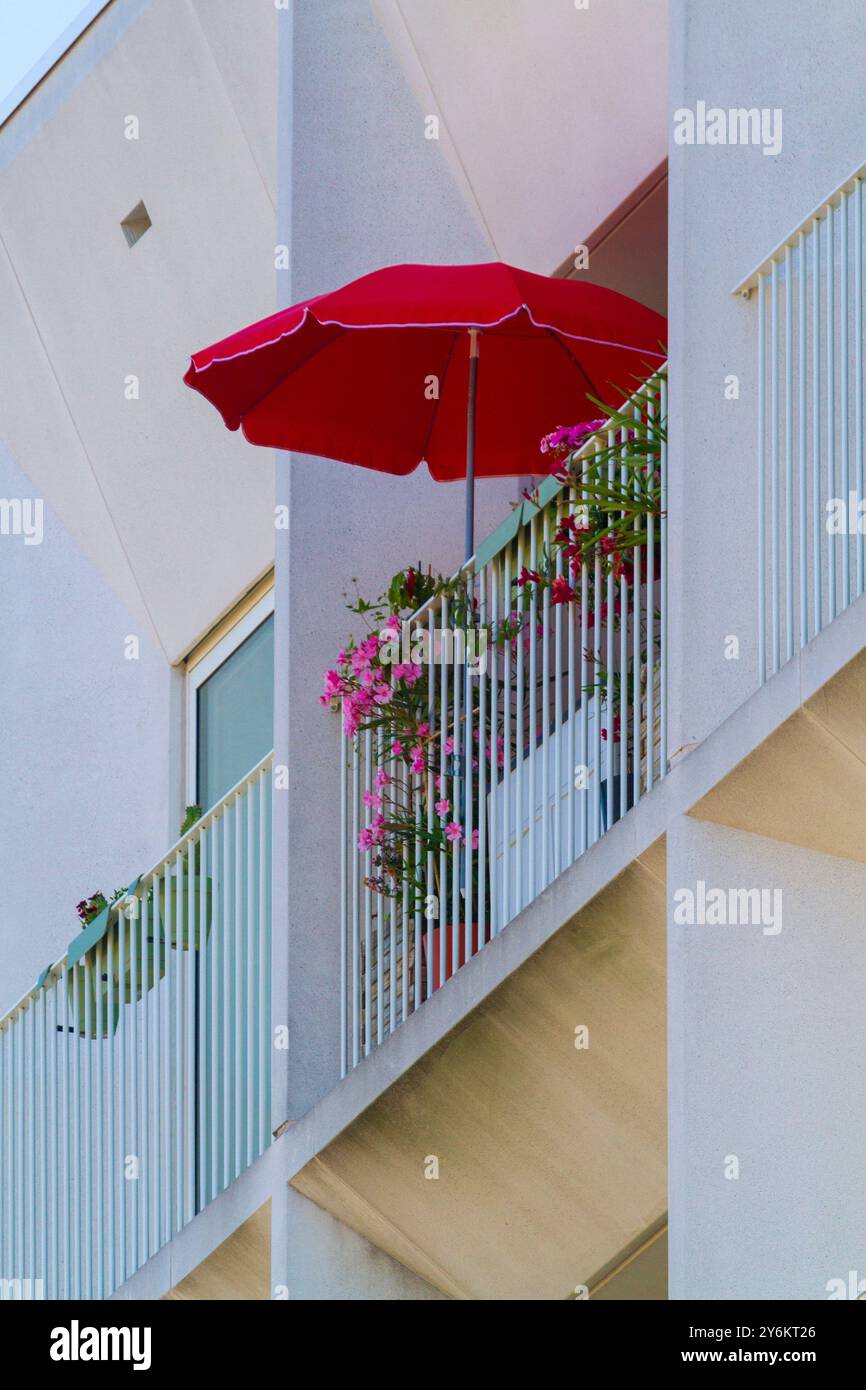 Building balcony with plant and parasol Stock Photo - Alamy