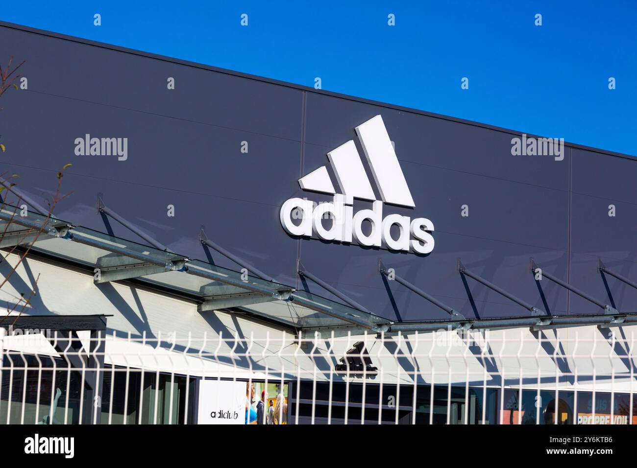 Company sign Adidas Stock Photo - Alamy