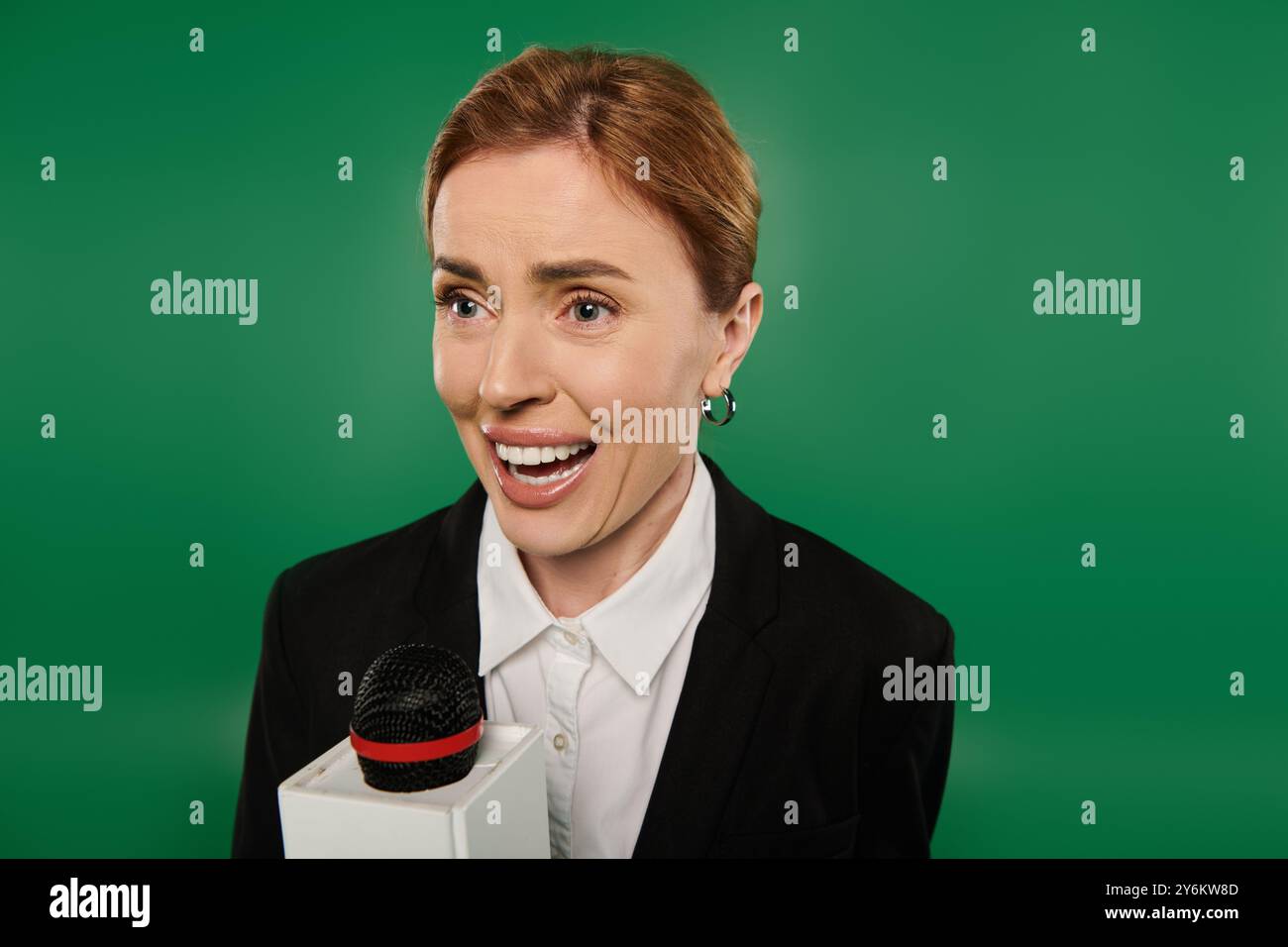 The TV presenter smiles warmly while speaking with the audience against ...
