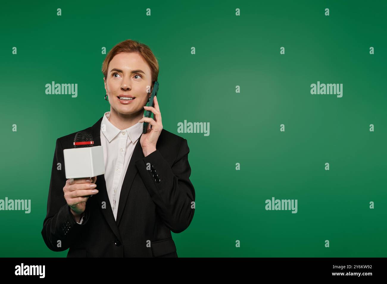 A poised TV presenter in elegant black attire communicates with viewers ...
