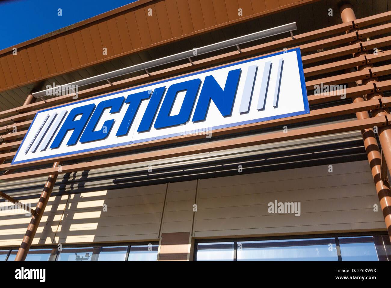 Action company sign Stock Photo - Alamy