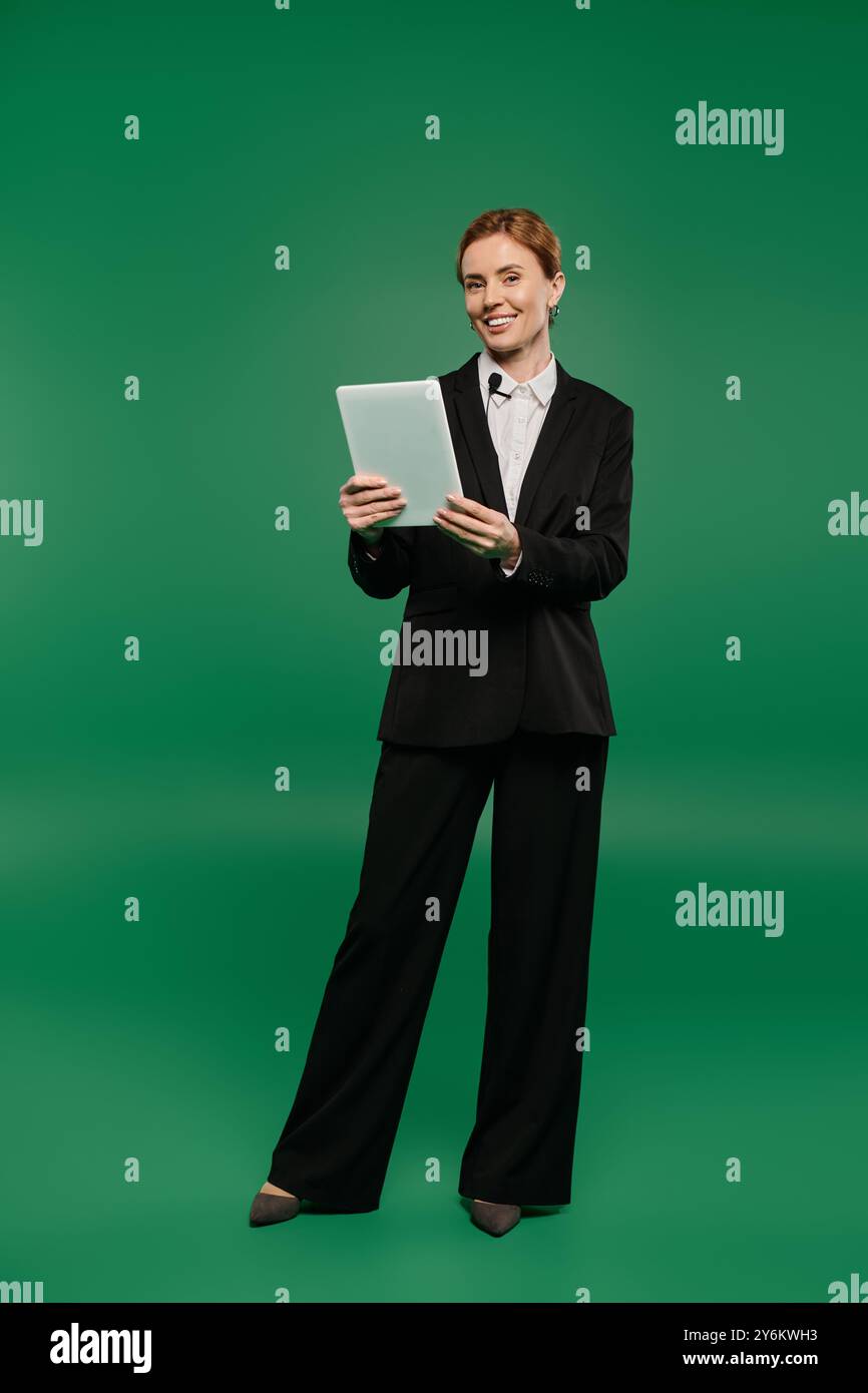 A stylish presenter in formal attire holding a tablet, set against ...