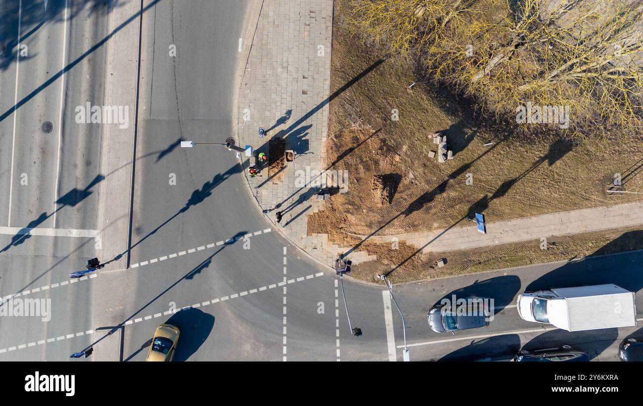 Aerial view of a road intersection with cars and pedestrians ...