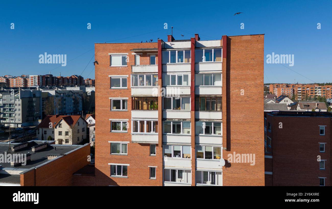 A modern brick apartment building with multiple balconies, showcasing ...