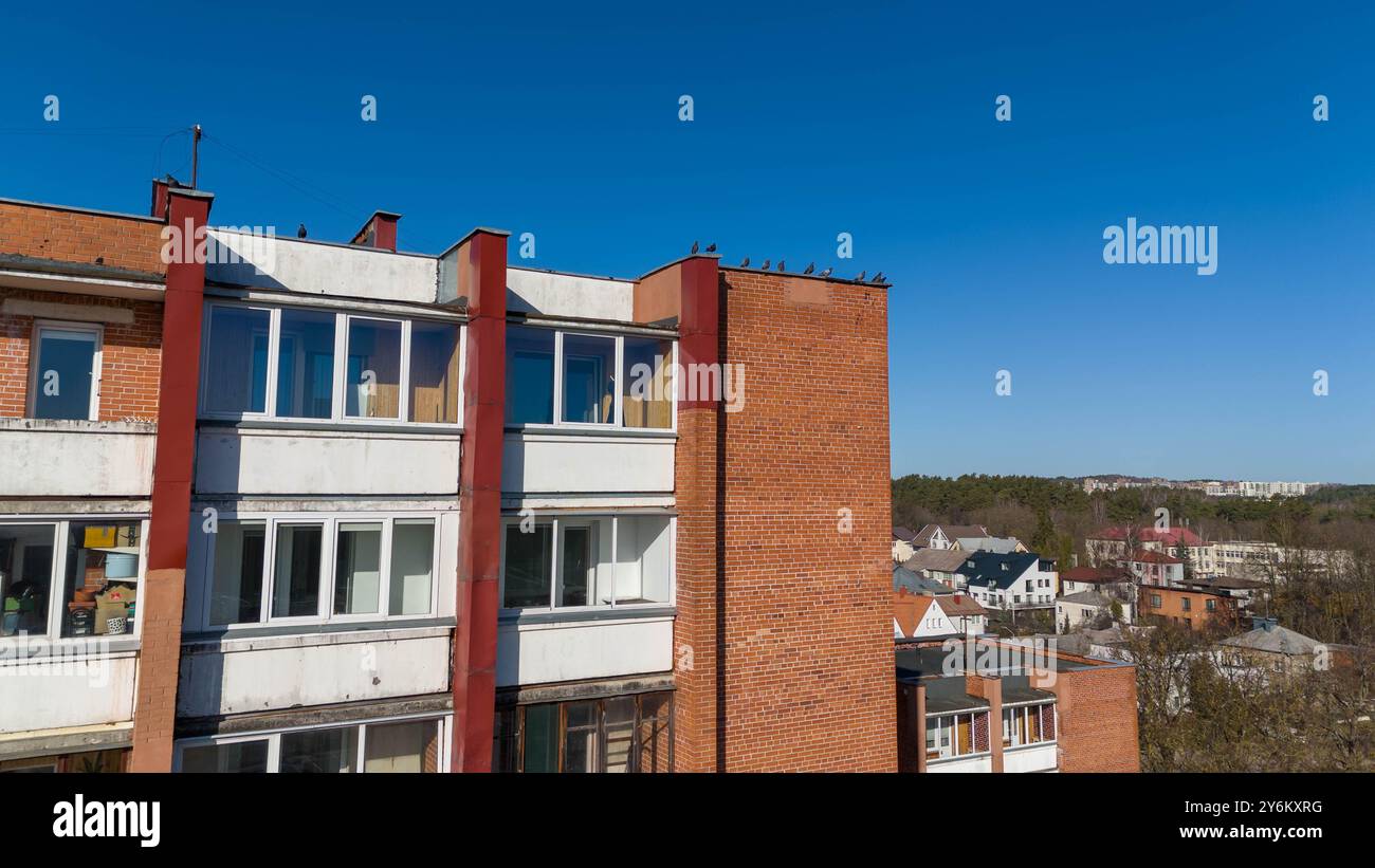 A modern brick apartment building with multiple balconies, showcasing ...