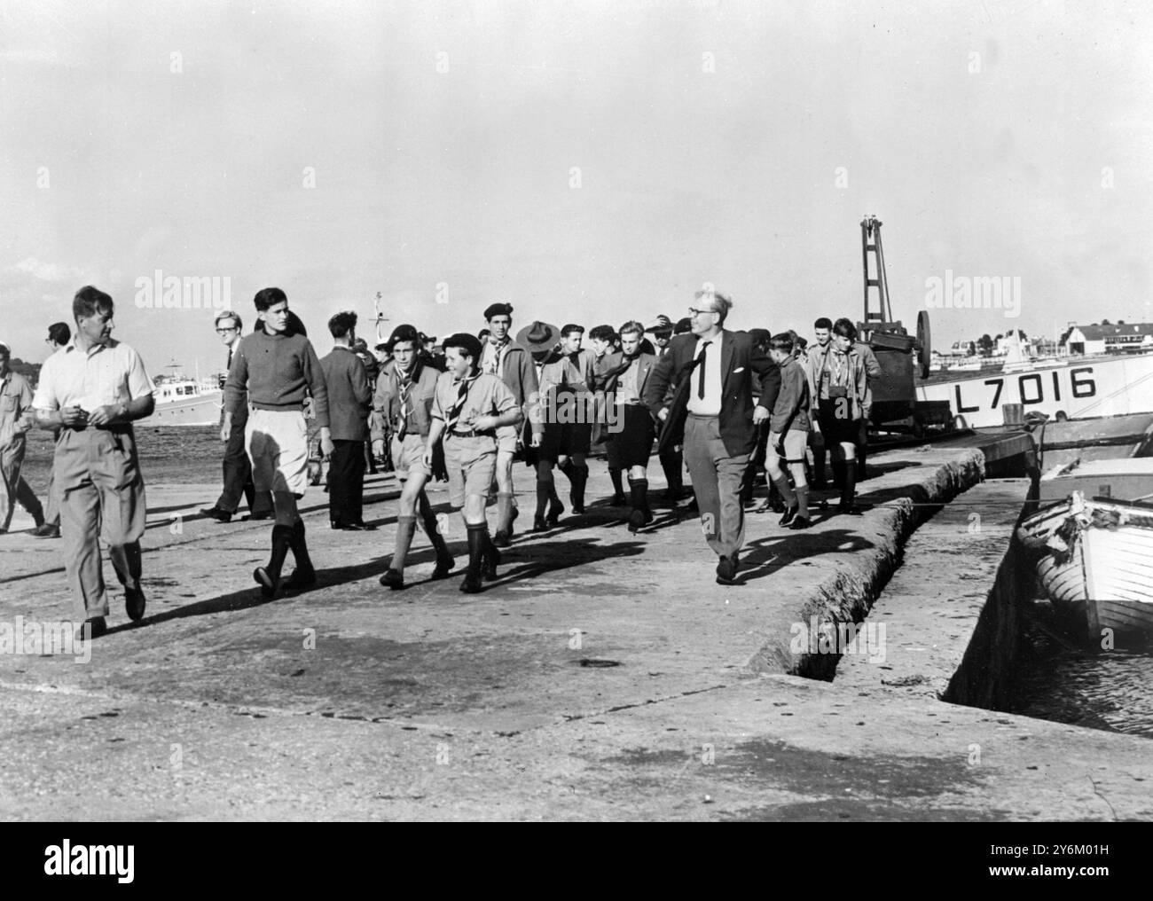 Boy on pier by boat Black and White Stock Photos & Images - Alamy