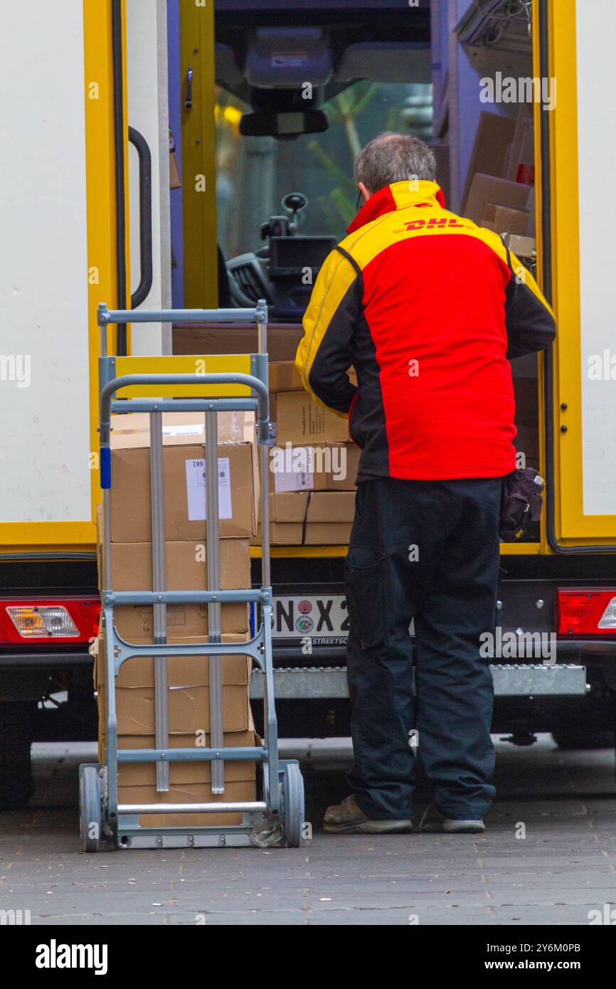 DHL delivery man in the back of the truck Stock Photo - Alamy
