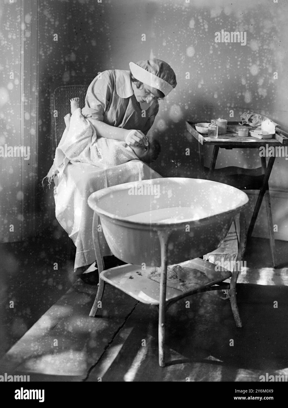 Order of the bath. Nurse washing a baby. Cleaning baby's eye. Leach's ...