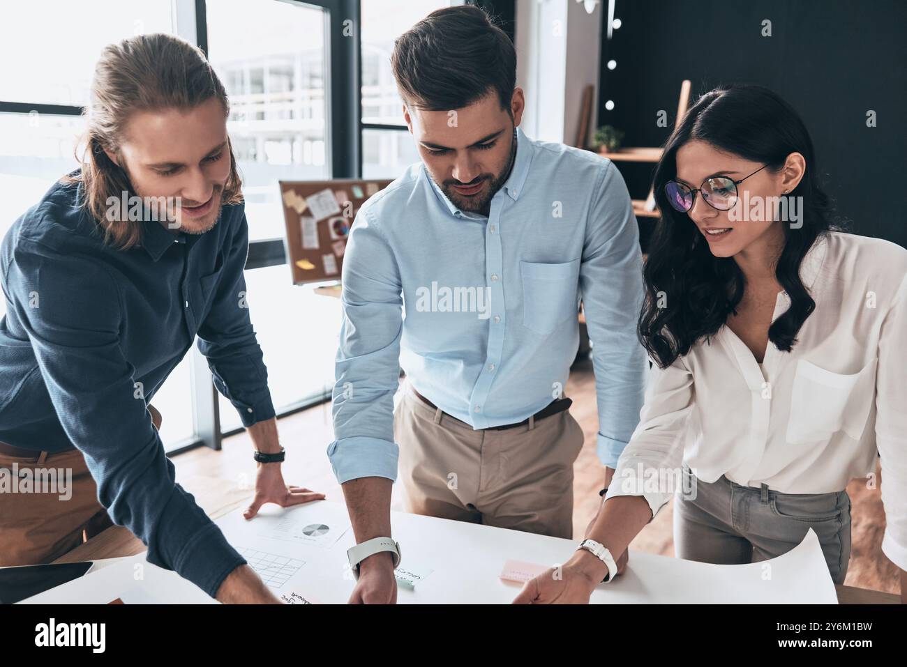 Thinking in one direction. Top view of young confident business people ...