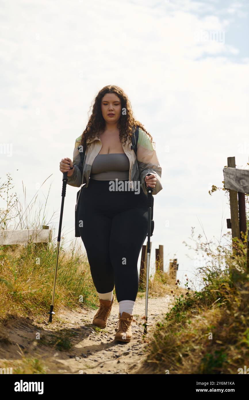A beautiful plus size woman explores a peaceful path in nature ...