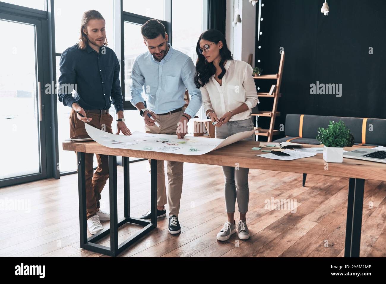 Brainstorming together. Full length of young confident business people ...