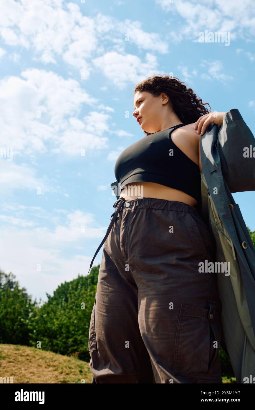 Woman stands amidst field wildflowers hi-res stock photography and ...
