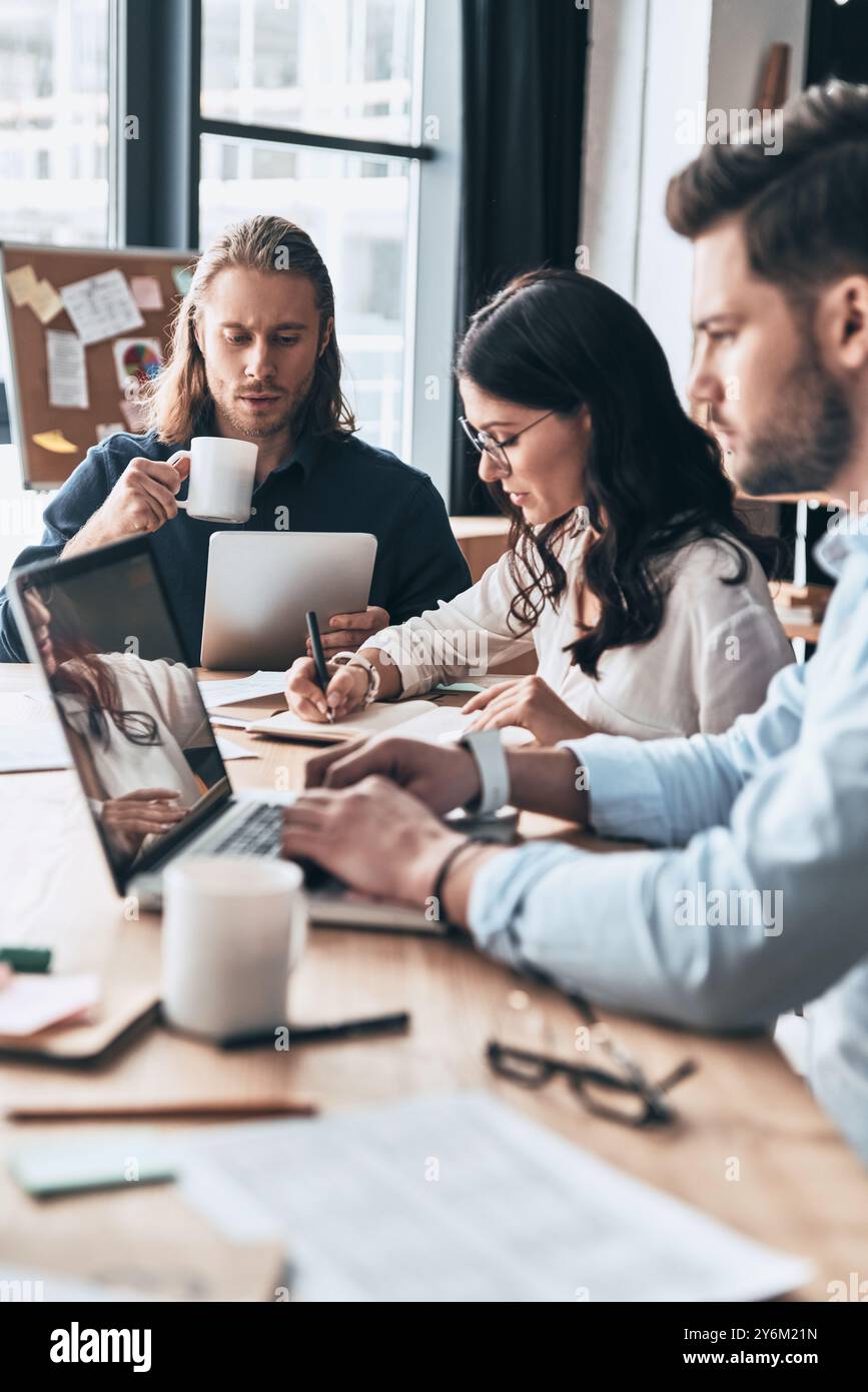 Everyone has things to do. Young modern colleagues in smart casual wear ...