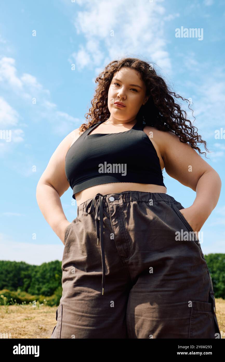 A beautiful woman embraces her curves, enjoying a peaceful moment in ...