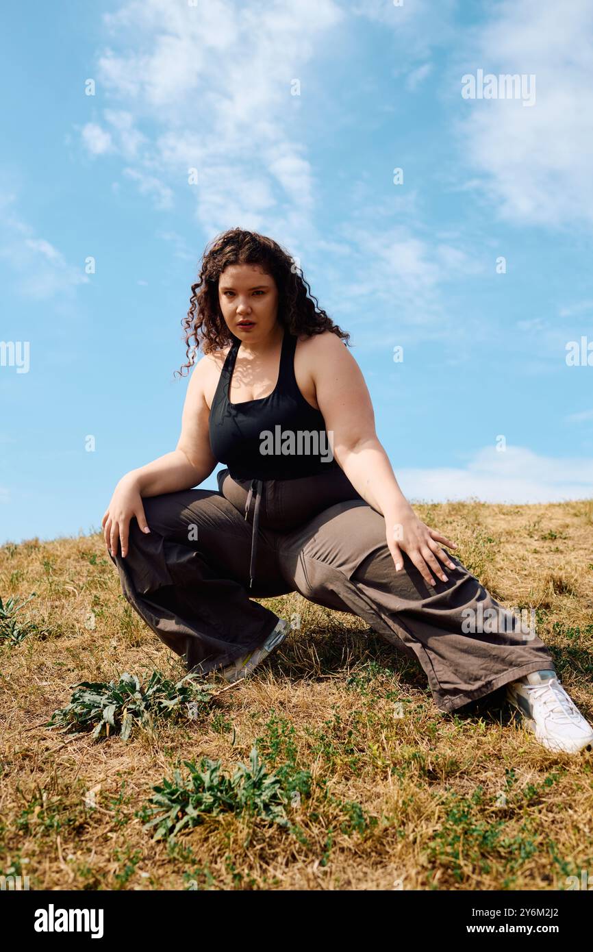 A confident plus size woman poses gracefully in a beautiful natural ...
