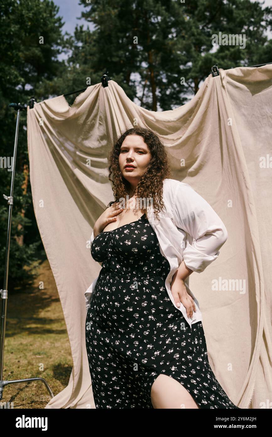 A radiant plus size woman poses gracefully outdoors, embracing the ...