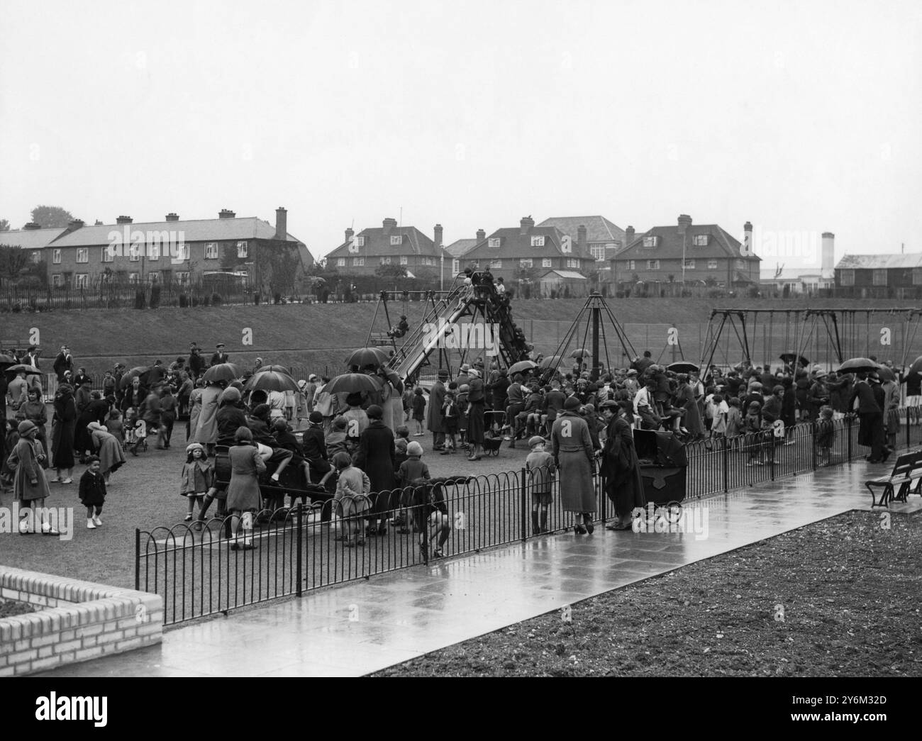 Very busy playground with children playing on the swings and slides ...
