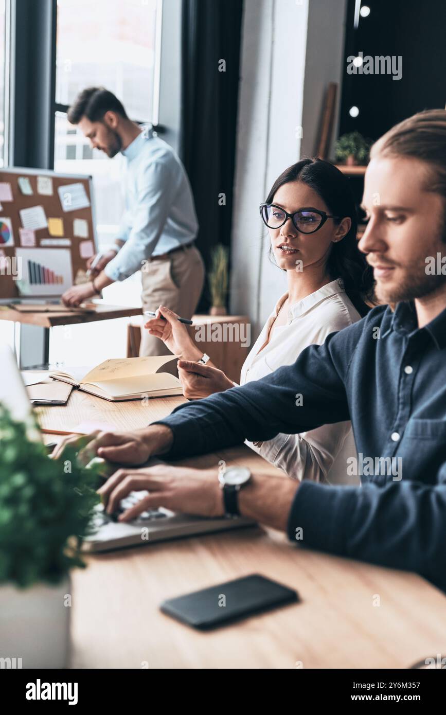 Choosing the right direction. Two young business people discussing ...