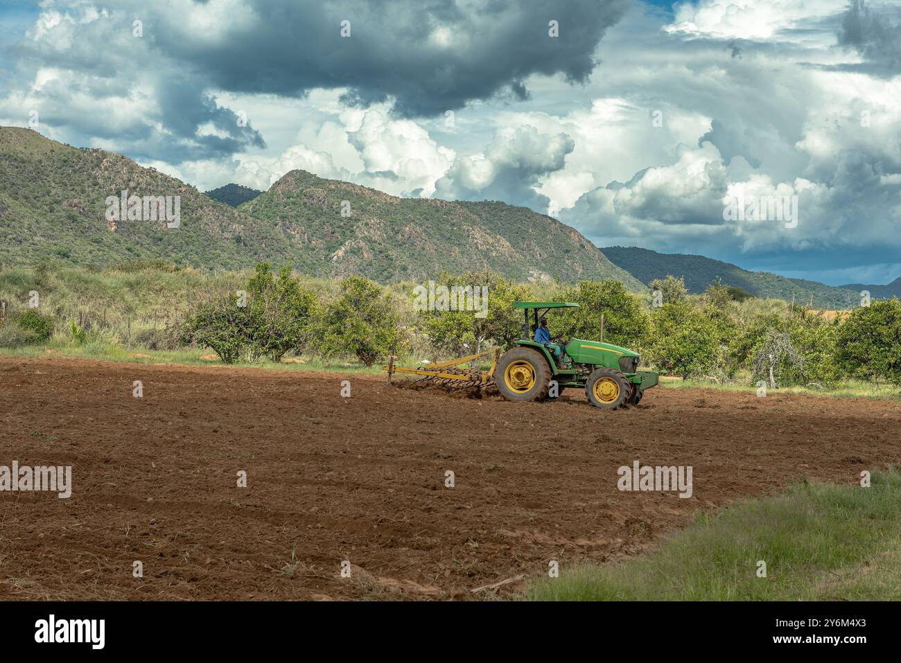 Farmer with green tractor prepares field for sowing, otavi, namibia ...