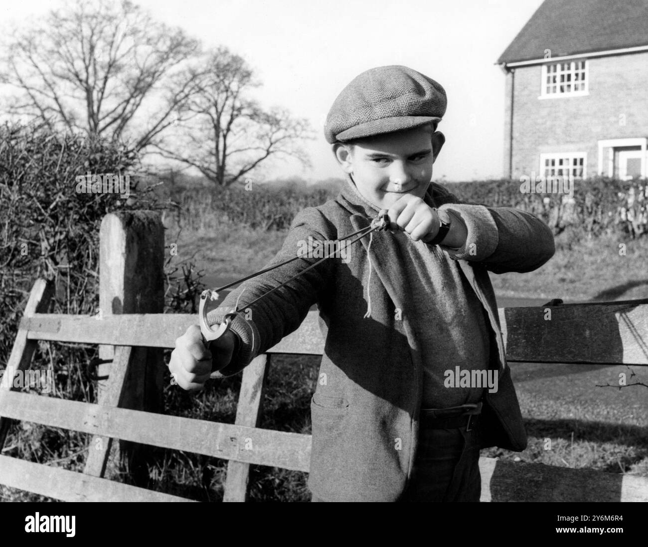 Boy playing with a catapult Stock Photo - Alamy
