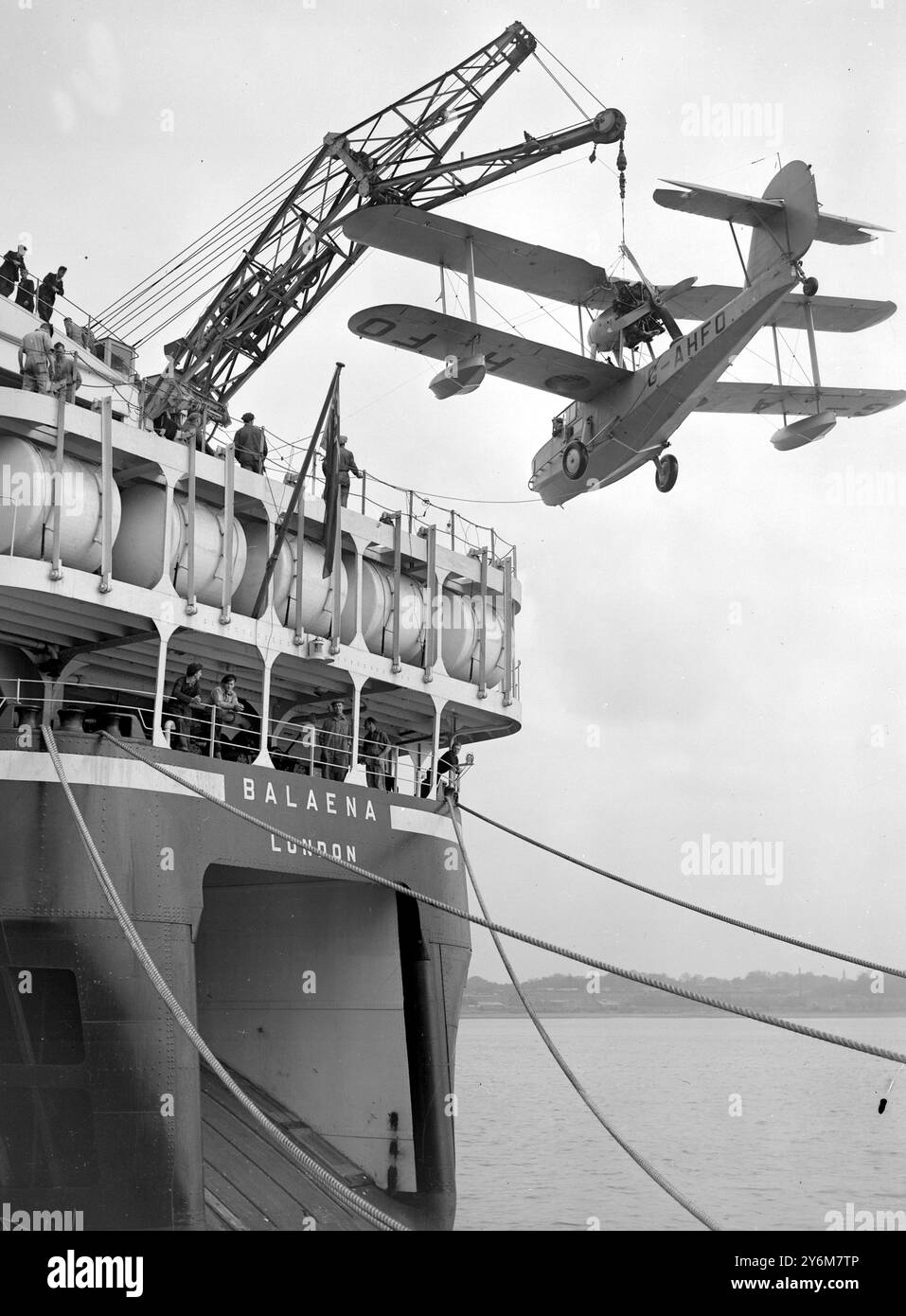 One of the Walrus seaplanes for spotting purposes being hoisted aboard ...