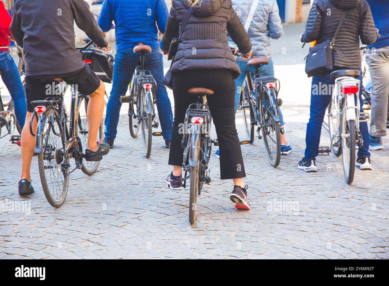 Group of cyclists at a stop in town Stock Photo - Alamy