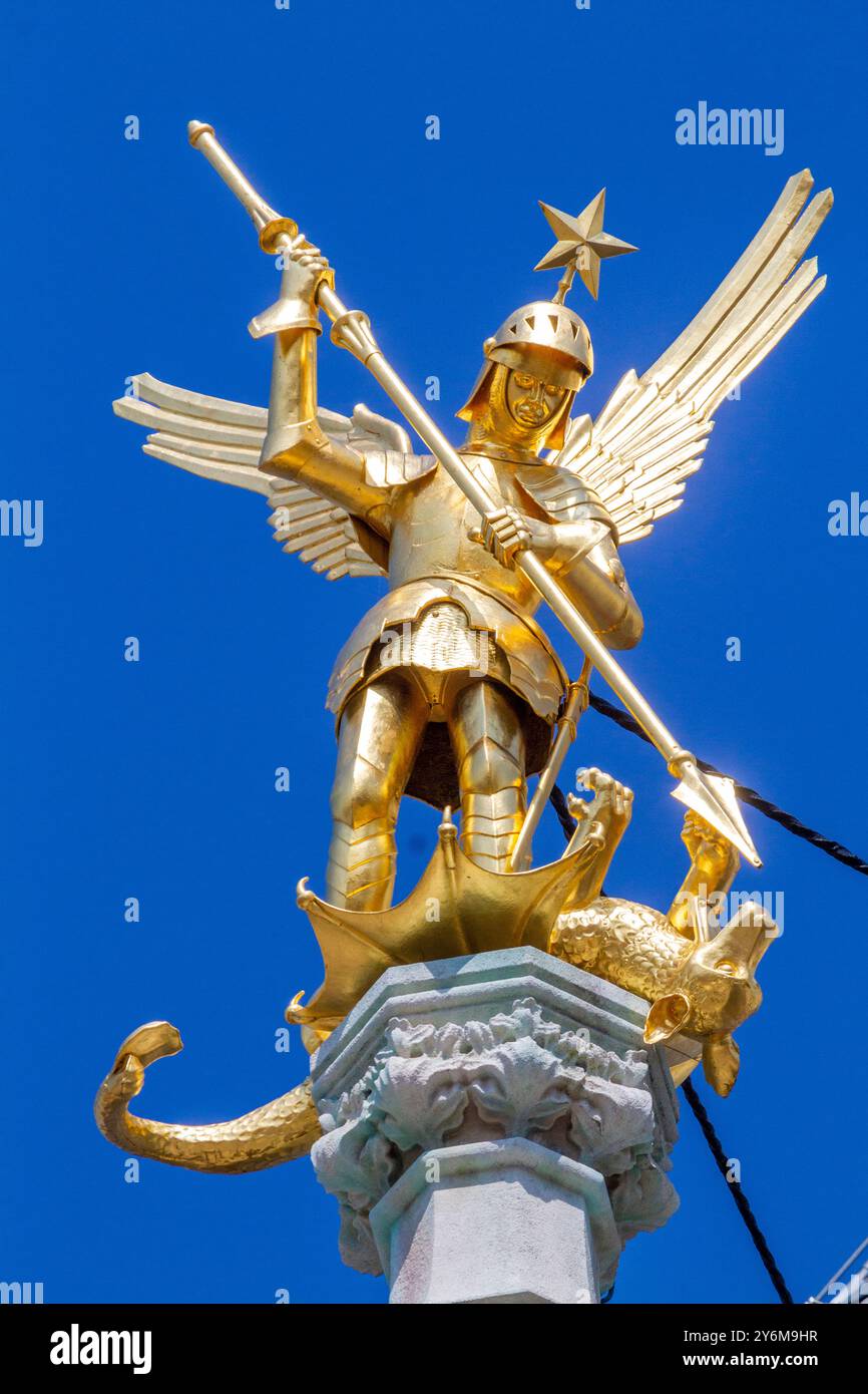 Europe, Belgium, Bruges. Town hall and its statue of St-Michel slaying ...