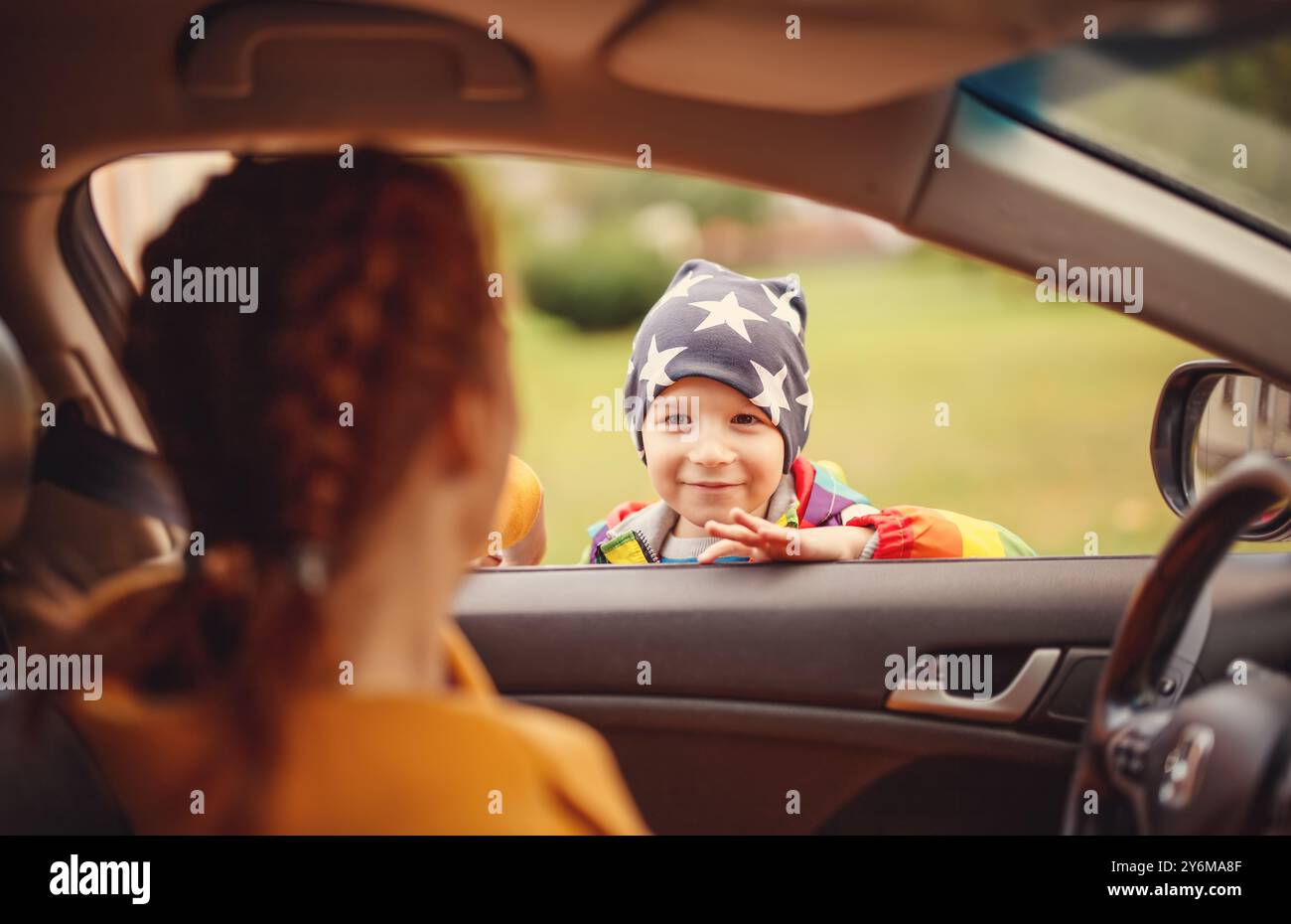 Mom bringing her child to school and saying goodbye to him Stock Photo ...