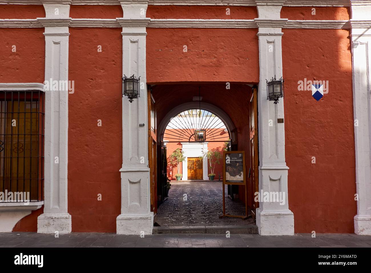 Stunning view of a historic colonial building with red walls and white ...