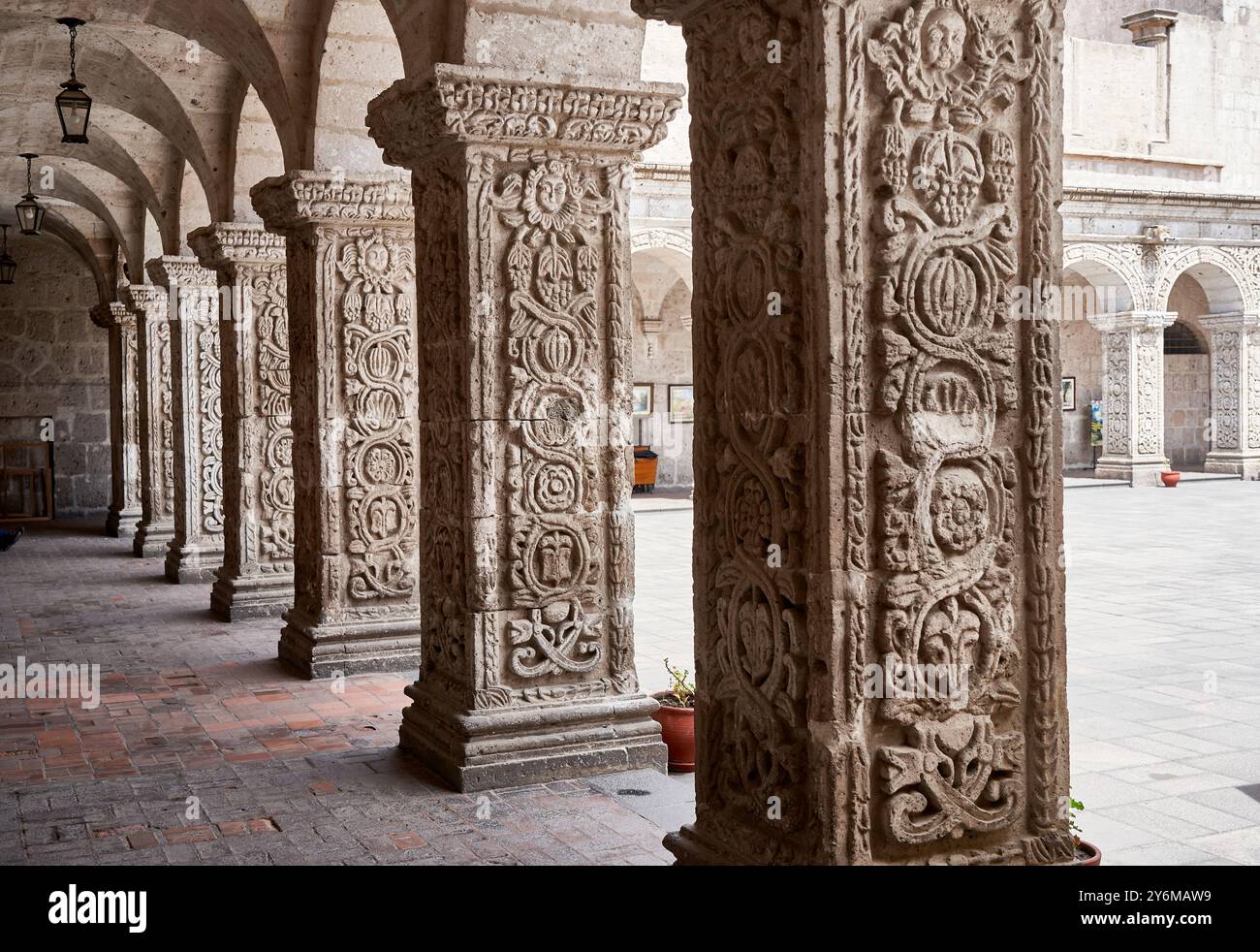 Ornate stone columns with detailed carvings line the historic arched ...