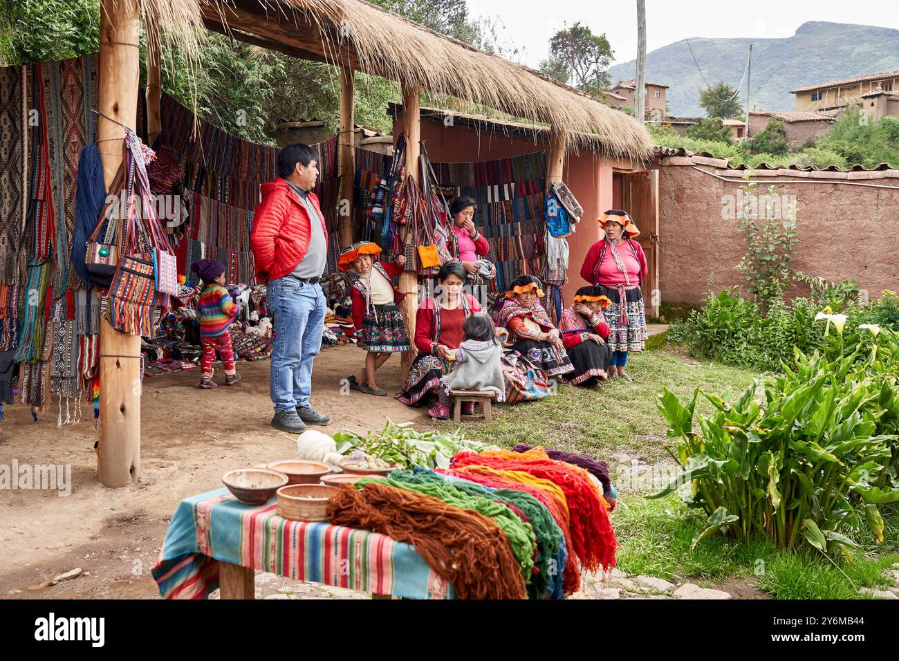 A vibrant Andean market in Chincero showcases people in traditional ...