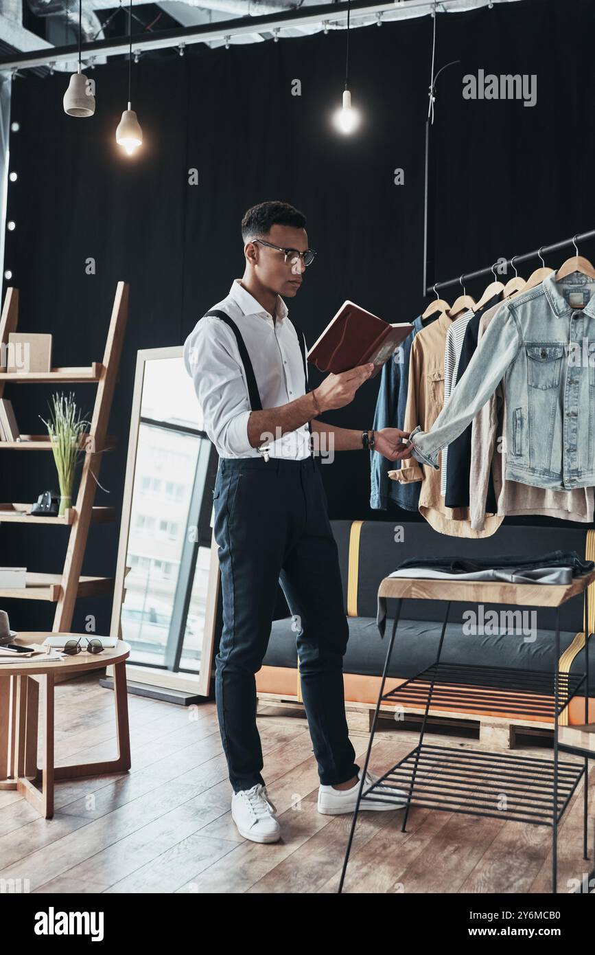 Checking every detail. Full length of good looking young man looking ...