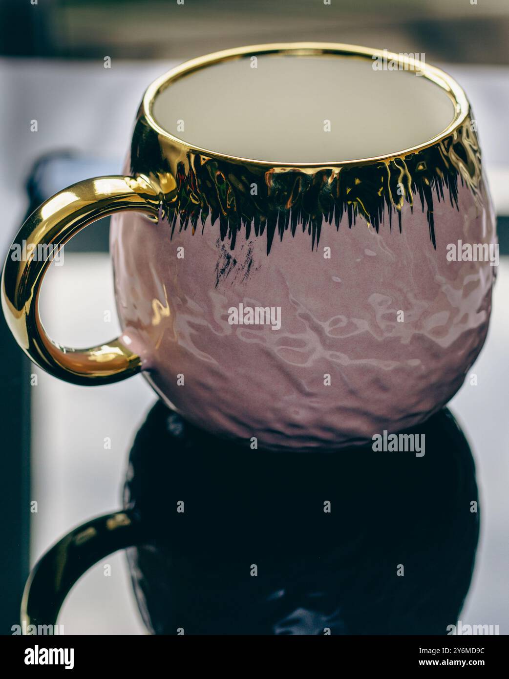 Pink teacup with gold details and gold handle Stock Photo - Alamy