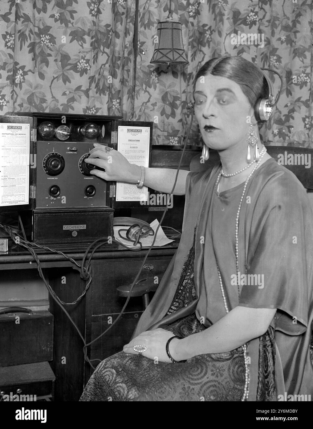 Mr Leslie Henson (as Gladys Cooper) listens in at the Winter Garden ...