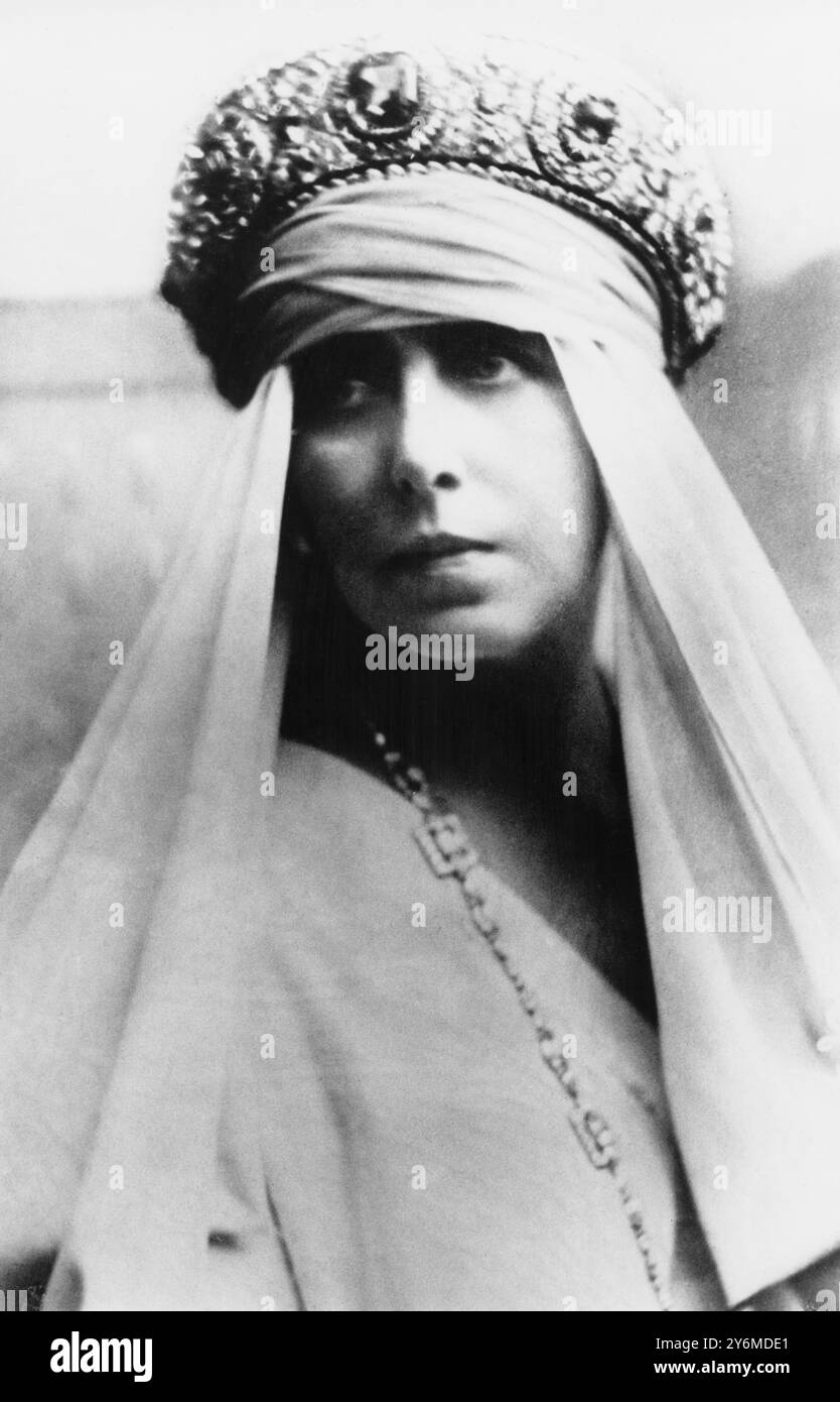 Queen of Rumania wearing a striking head dress. She is at present ...