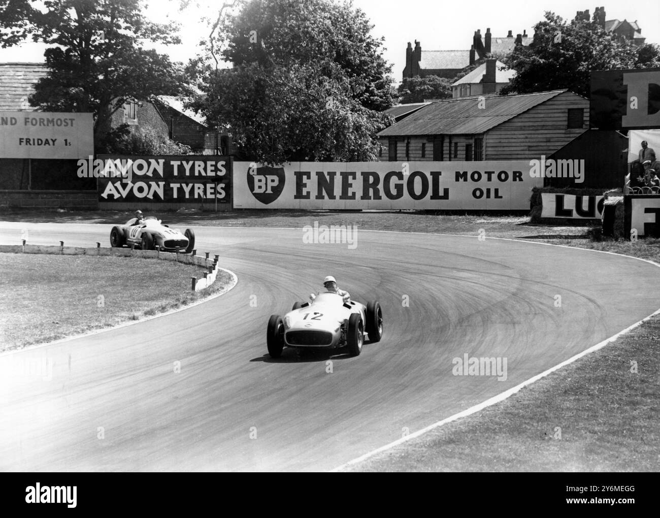 British racing driver Stirling Moss No 12, takes the lead from Fangio ...