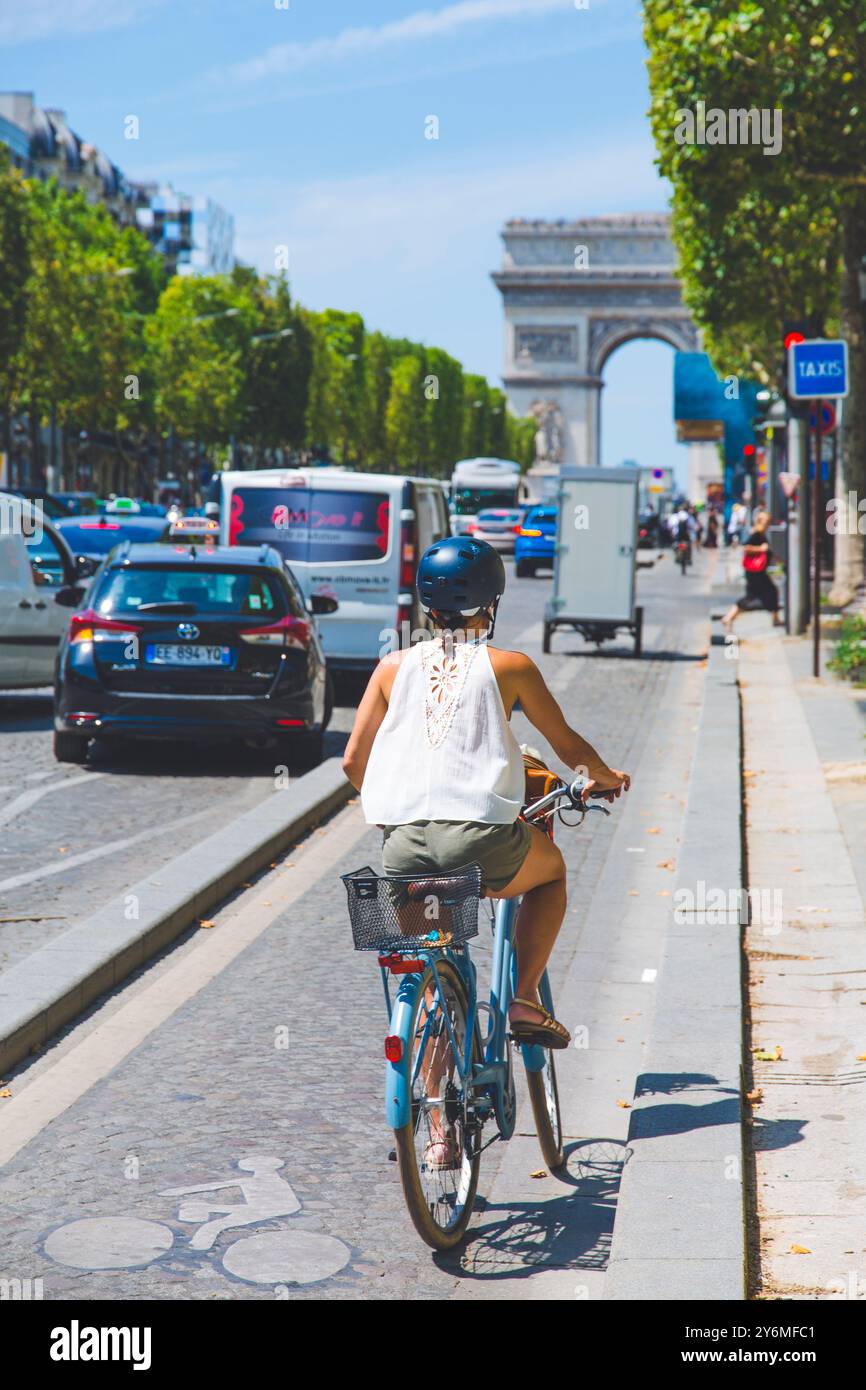 France, Paris, Bike path in the city center. Cyclists on a cycle path ...
