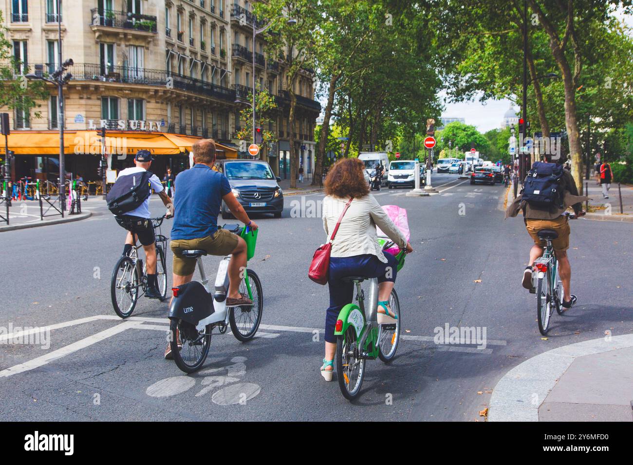 France, Paris, Bike path in the city center. Cyclists on a cycle path ...