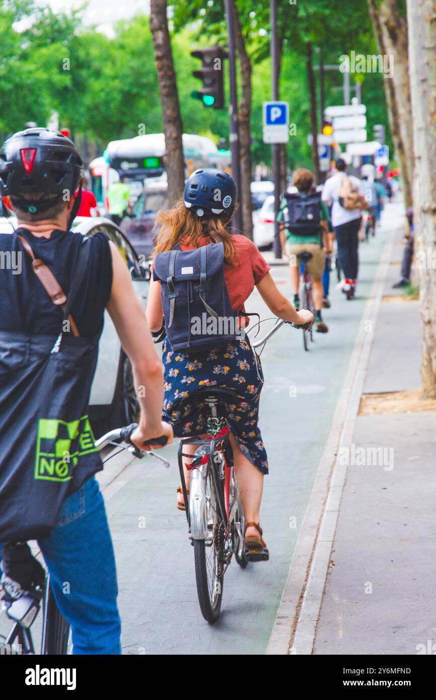 France, Paris, Bike path in the city center. Cyclists on a cycle path ...