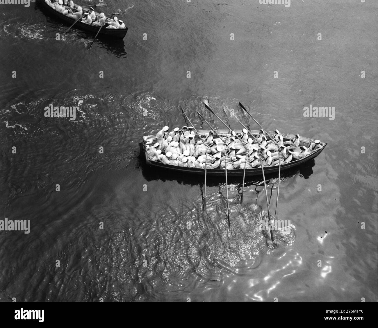 Naval cadets rowing in packed boat during an 'Abandon Ship' exercise ...