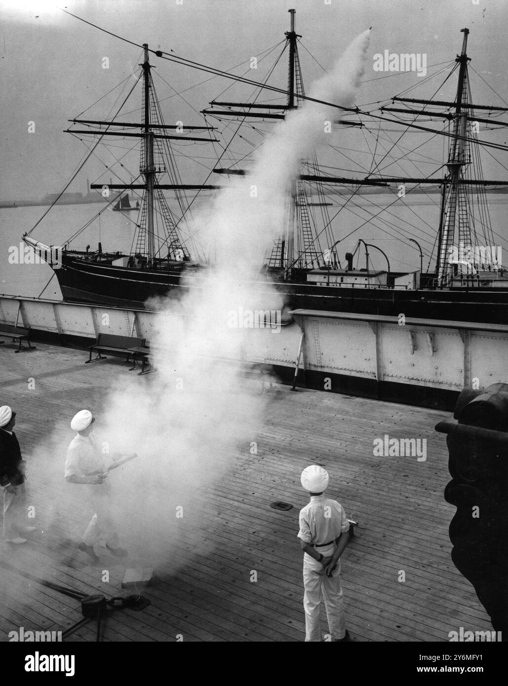 Naval cadets fire a smoke rocket with a lifeline over the rigging of ...