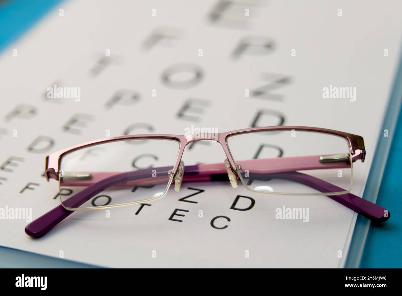 Stylish glasses resting on an eye exam chart. Perfect for vision ...