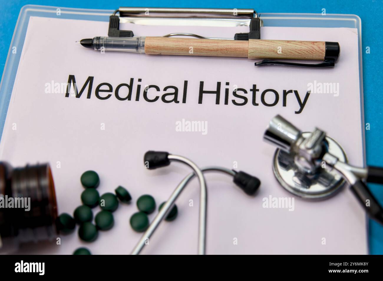 Blank medical form, stethoscope, pills, and pen - ready for your health ...