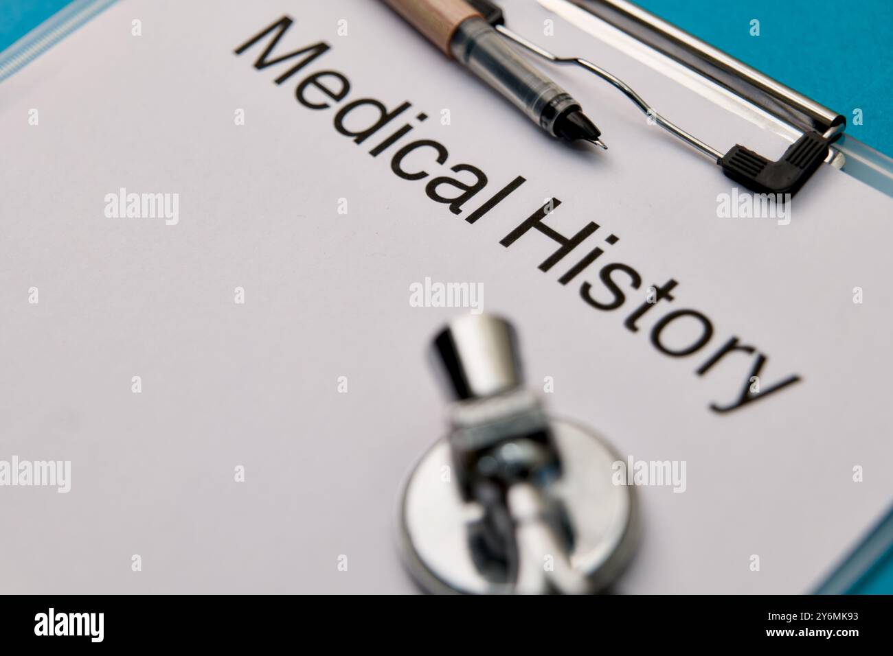 Blank medical history form with pen & stethoscope on blue, ready for ...