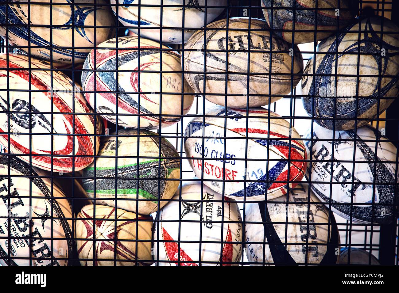 Rugby balls behind an iron gate Stock Photo - Alamy