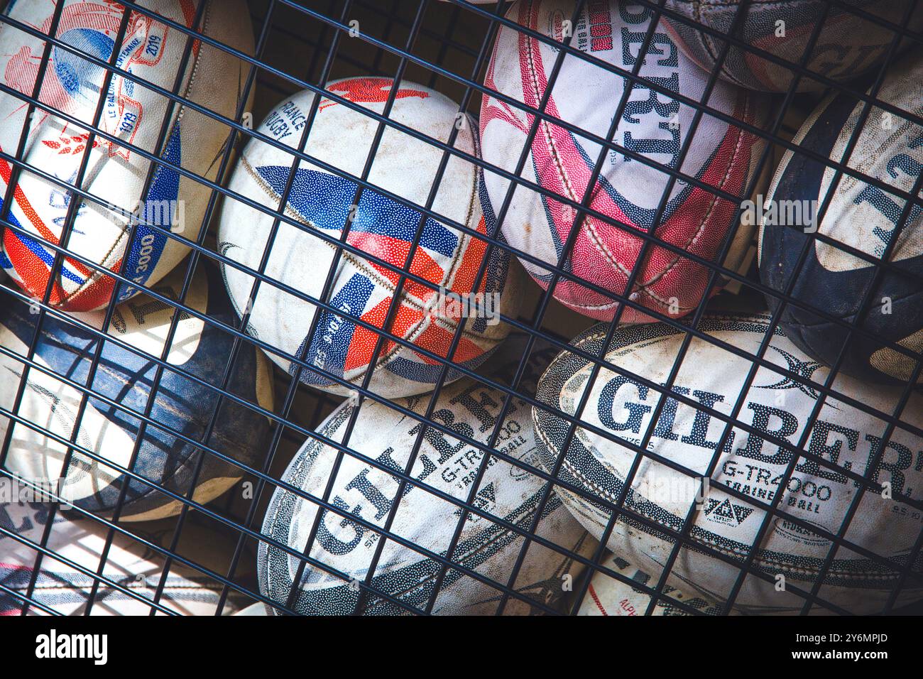 Rugby balls behind an iron gate Stock Photo - Alamy
