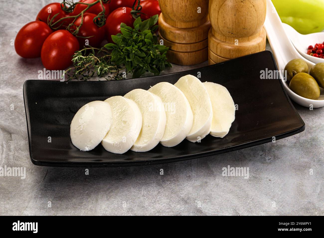 Organic mozzarella cheese slices in the plate appetizer Stock Photo - Alamy