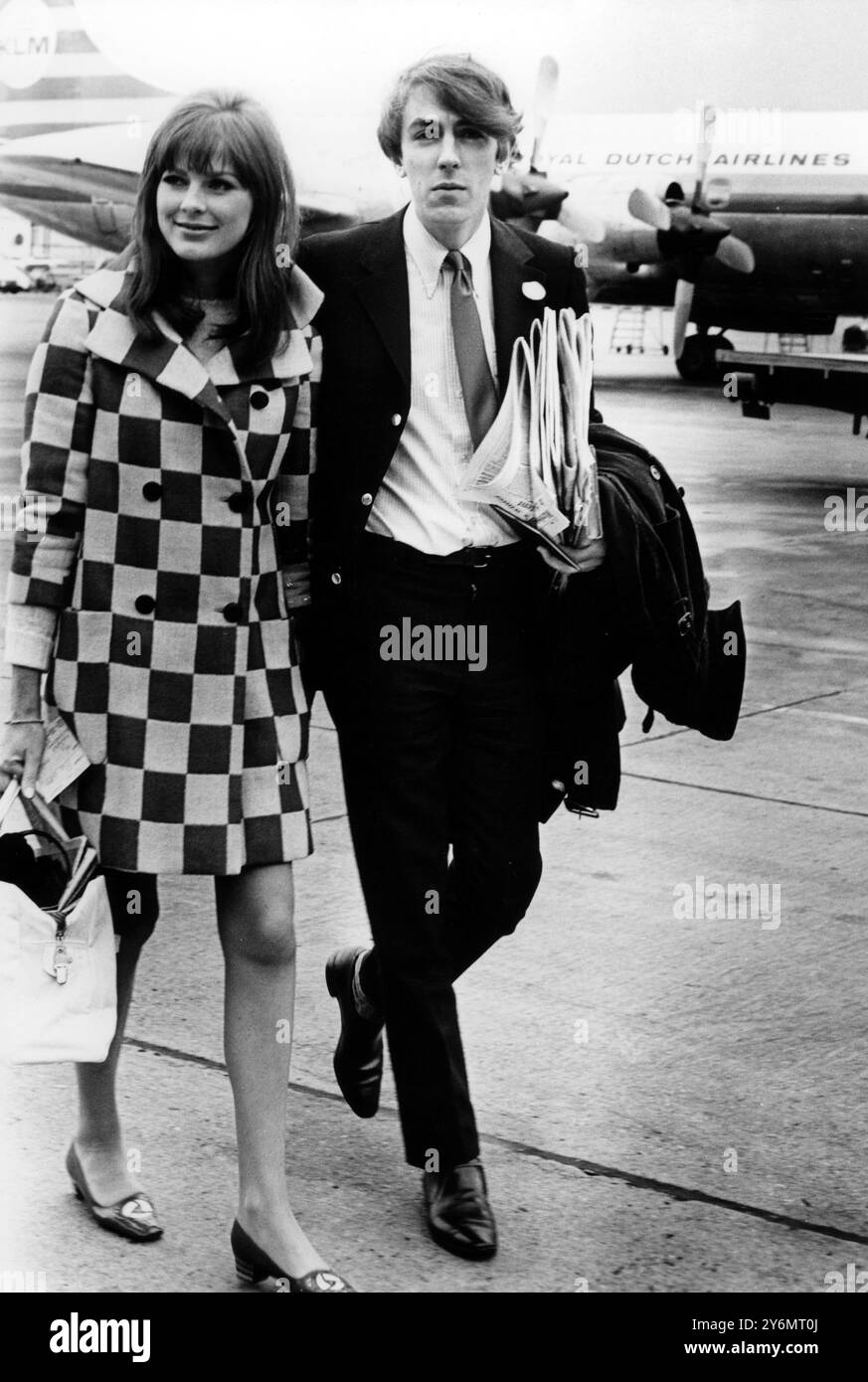 Peter Cook walks with actress Paulene Stone at London airport where ...