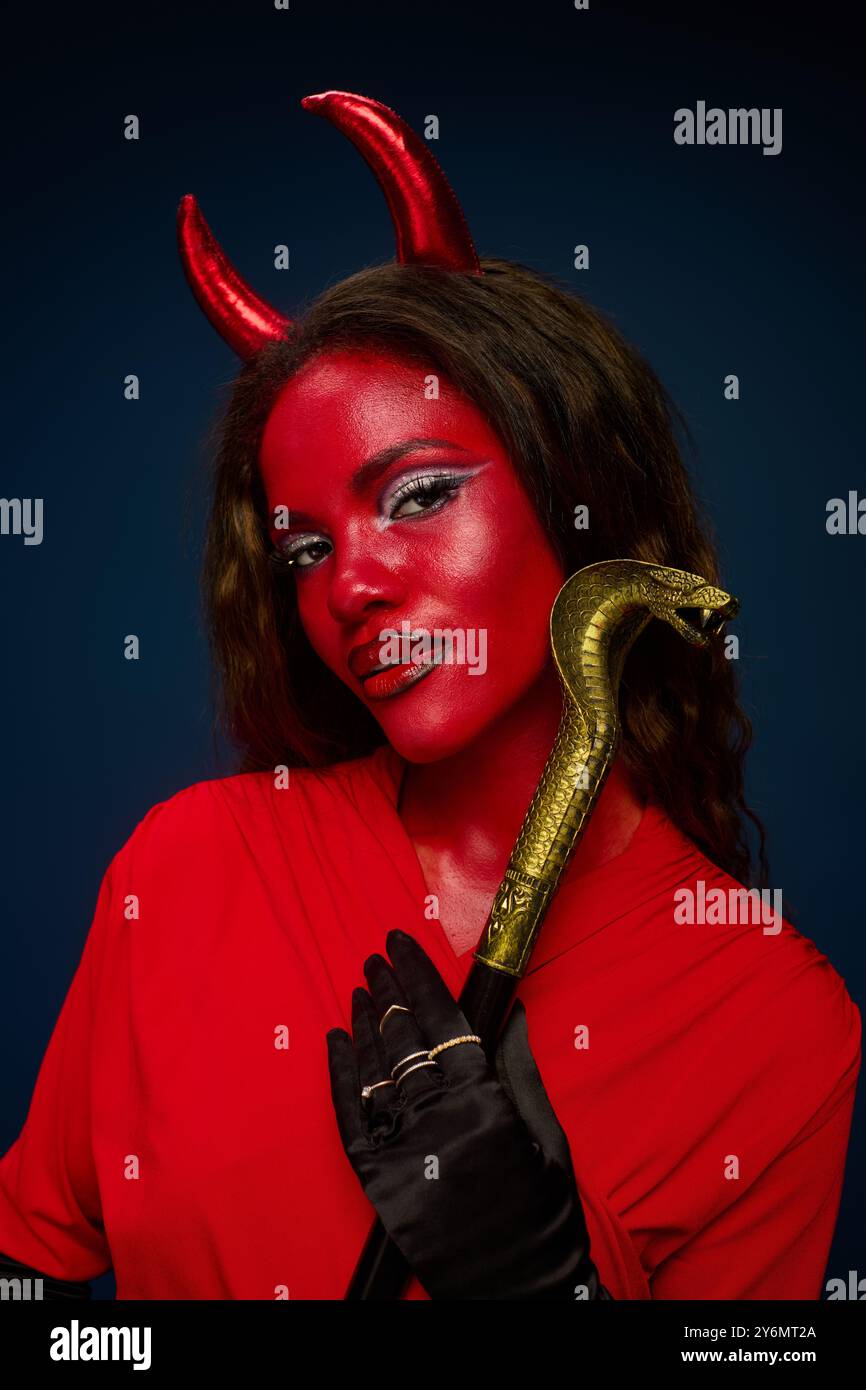 This woman embodies Halloween with a bold red outfit and devilish ...