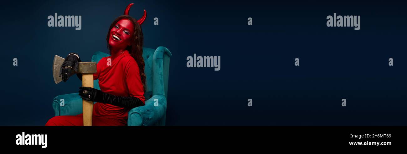 Dressed in red with devil horns, the confident woman embraces the ...